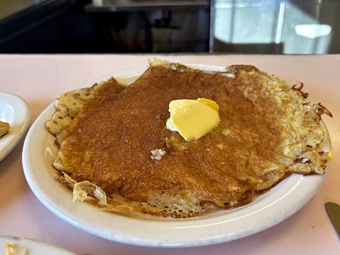 This golden-brown pancake could double as a frisbee, except it's way too delicious to throw and perfectly sized for serious syrup absorption.