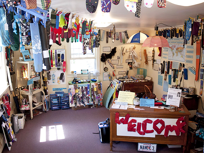 Umbrella covers dangle like colorful stalactites from the ceiling, transforming this tiny space into a cave of everyday wonders.
