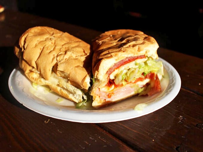 Layer upon glorious layer of meats, veggies, and cheese create a sandwich architecture so perfect it deserves its own blueprint.