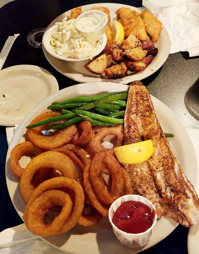 Behold the Lake Erie walleye in all its golden-fried glory, surrounded by its loyal companions: fries, slaw, and those perfect onion rings.