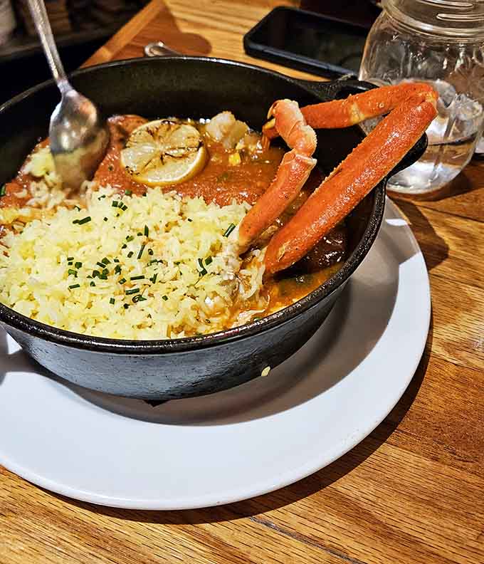 Behold the jambalaya that's causing all the fuss, arriving in a sizzling cast-iron skillet of pure Louisiana magic.