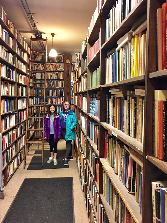 Young explorers navigate the literary labyrinth, proving that the magic of discovering books transcends generations.