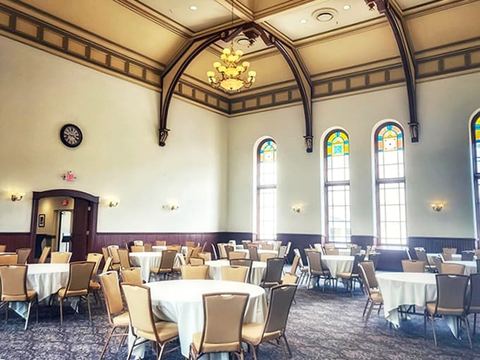 Kirkbride Hall's elegant dining space, with soaring ceilings and stained glass windows, now hosts events where laughter has replaced the institutional quiet.