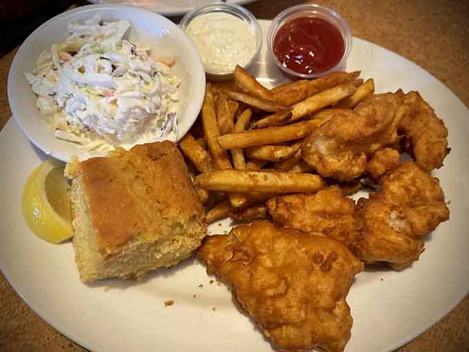 Behold the Friday Fish Fry in all its golden glory, complete with crispy fries, tangy coleslaw, and that essential wedge of lemon.