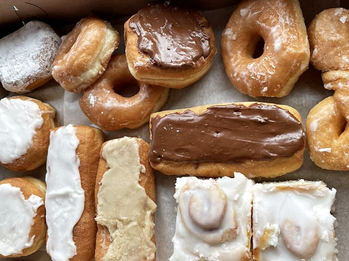 Behold the donut case of dreams, where chocolate, vanilla, and glazed varieties compete for your attention like delicious beauty pageant contestants.