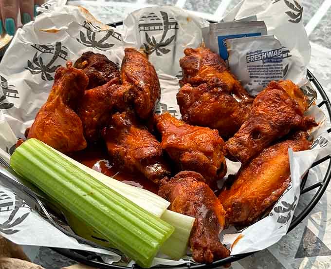 These buffalo wings glisten with sauce and promise the kind of flavor that makes you forget your own name.