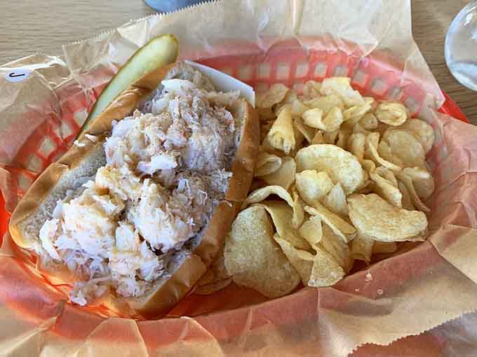 Golden crab meat piled high on a buttered bun with crispy chips, this is what seaside dreams are made of, folks.