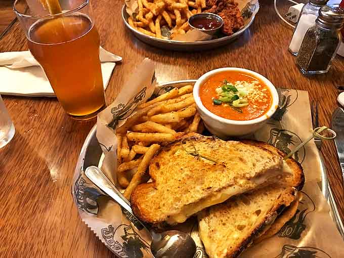 Melted cheese oozes between perfectly toasted sourdough, accompanied by a bowl of tomato soup that's begging for a dip.