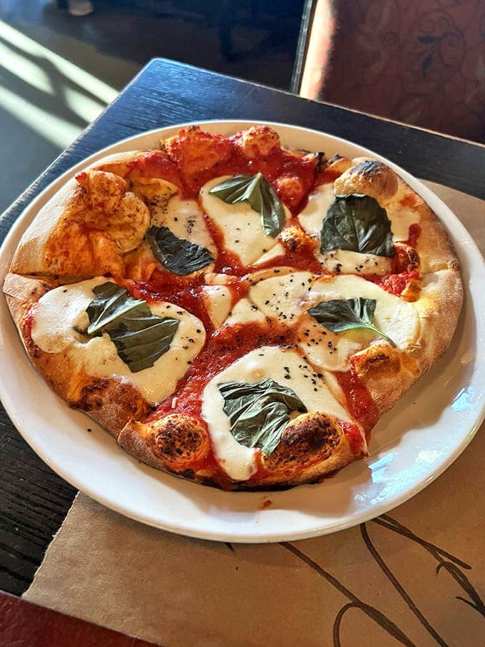 This Margherita pizza isn't just food&mdash;it's edible art with perfectly blistered crust, pools of fresh mozzarella, and fragrant basil leaves.