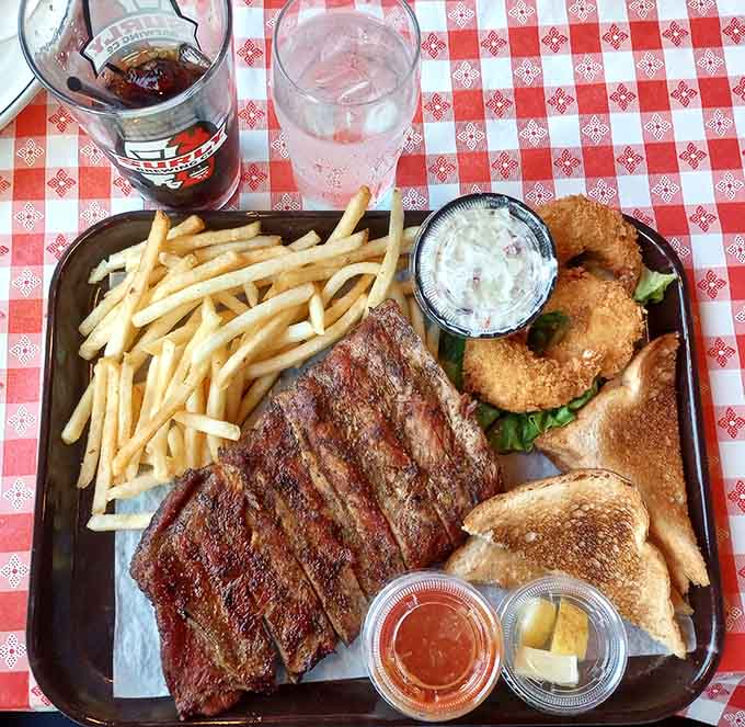 Behold the rib plate in all its glory: tender meat, crispy fries, and enough napkins to clean up after the inevitable sauce situation.