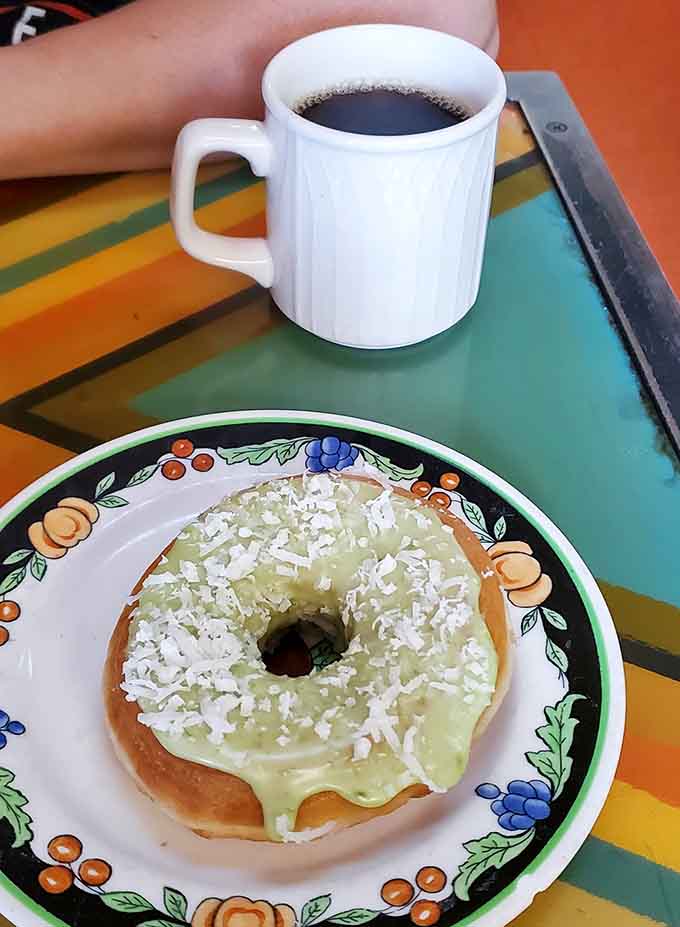 This key lime donut topped with coconut shavings pairs perfectly with coffee, creating a breakfast combo that'll make you forget it's Monday.