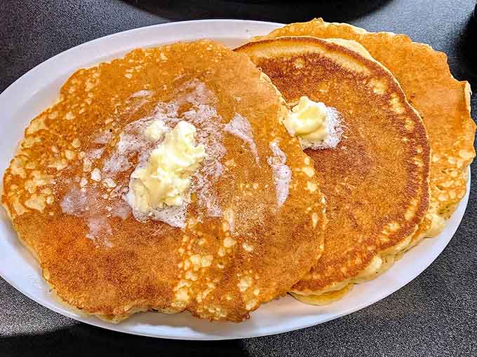 Golden perfection achieved: these pancakes are so fluffy they practically float off the plate, ready for their maple syrup baptism.