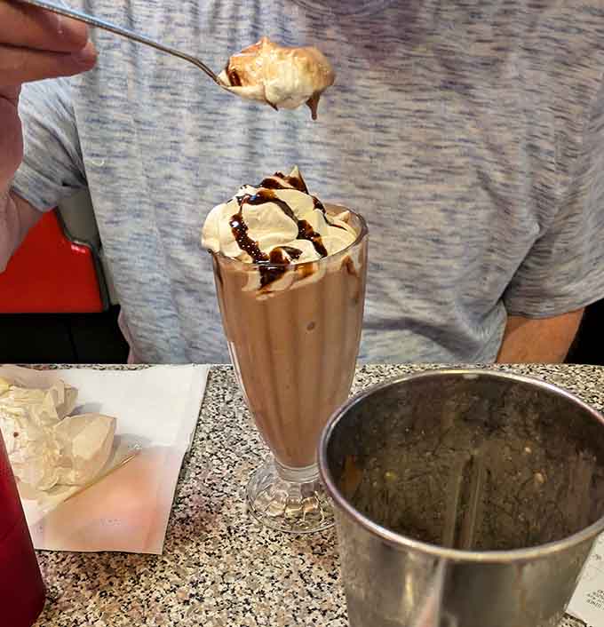 This towering chocolate milkshake topped with whipped cream is basically happiness in a glass, and yes, it tastes even better than it looks.