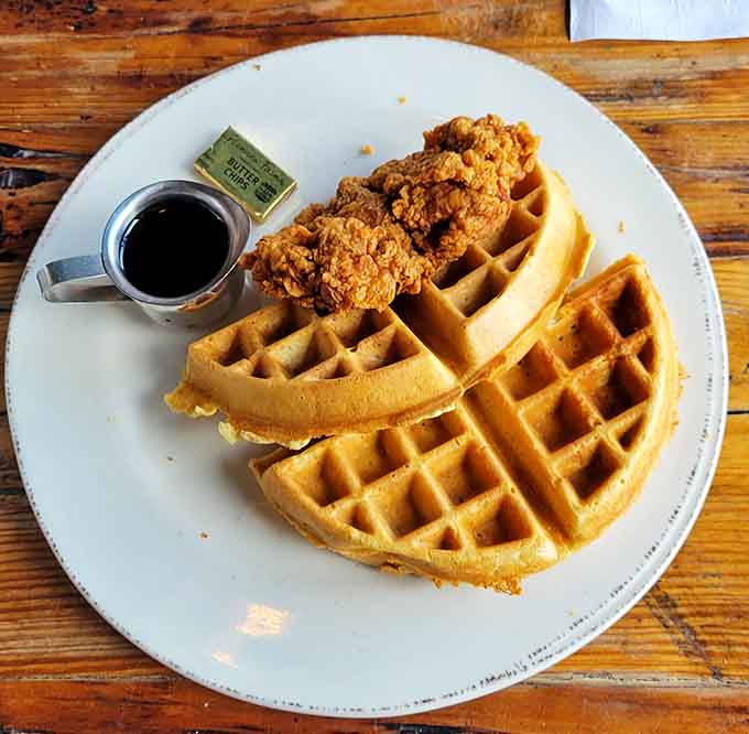 Behold the golden, crispy chicken perched atop fluffy waffles, a sweet and savory combination that'll make you question every breakfast choice you've made before.