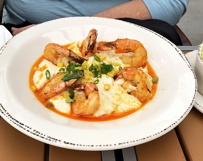 Plump shrimp nestle into creamy grits like they were always meant to be together, creating a dish that'll make you forget you're nowhere near the Mason-Dixon line.