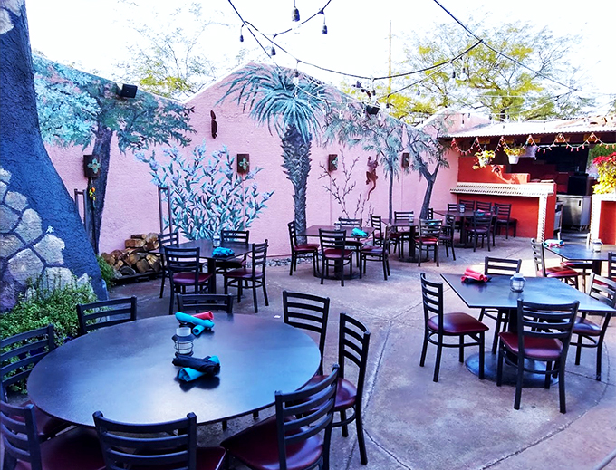 A desert oasis awaits on the patio, where painted palms and twinkling lights create pure Arizona magic.