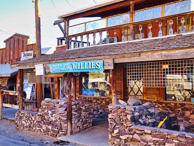 Outlaw Willie's storefront captures the rugged charm of Oatman, with stone foundations and weathered wood that's witnessed decades of desert stories.