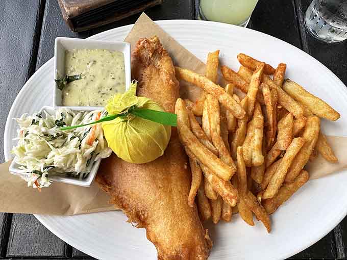 Golden, crispy fish and chips that could make a grown person weep with joy, served with fries that understand their assignment perfectly.