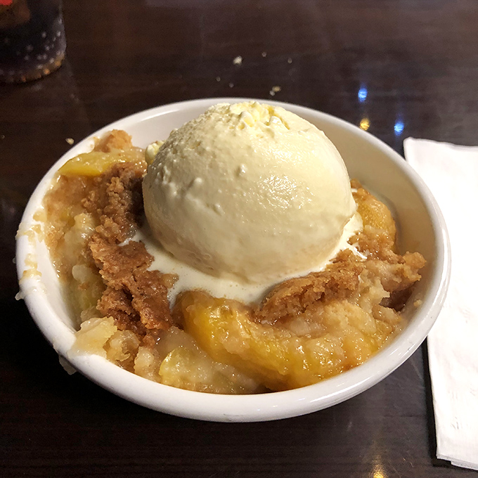 This peach cobbler isn't just dessert&mdash;it's a religious experience. Warm, buttery crust meets cinnamon-kissed peaches under melting vanilla ice cream.