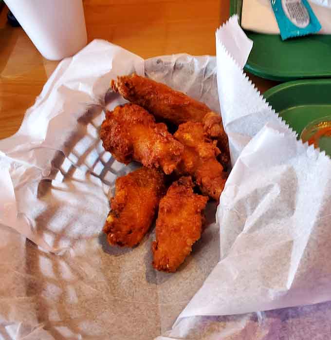 Golden, crispy chicken wings that could make a grown adult weep with joy, served piping hot in their basket.