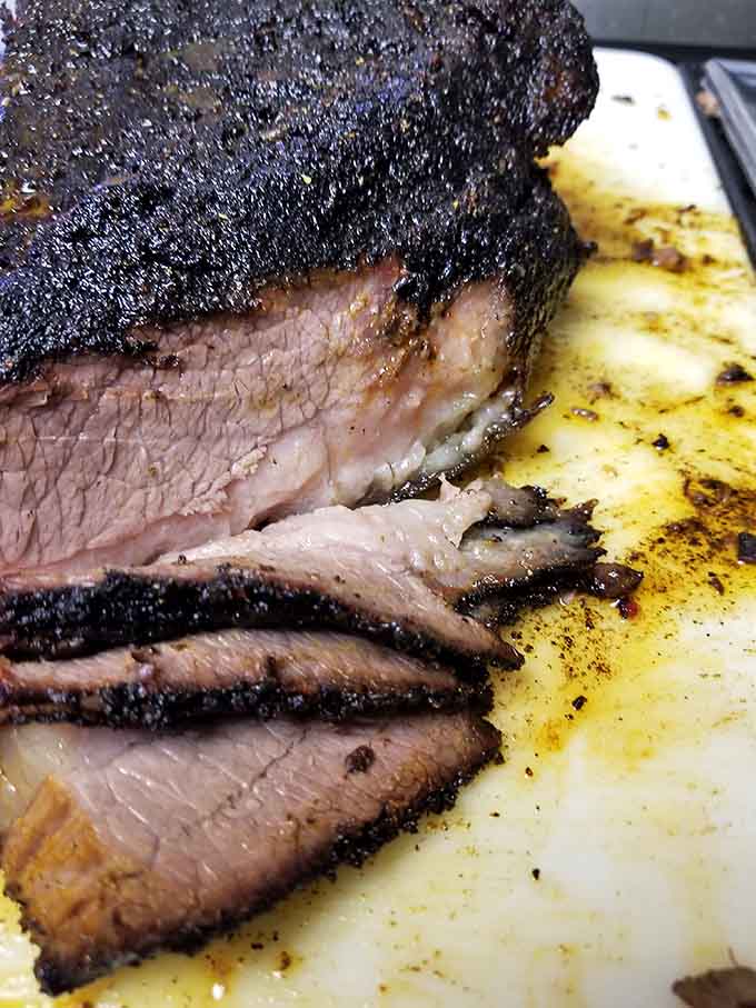 Behold the brisket that dreams are made of, sporting that perfect bark and smoke ring that signals hours of patient smoking.