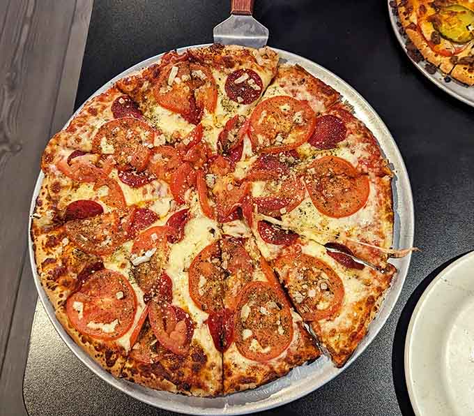 When pepperoni meets sliced tomatoes on a golden crust, magic happens in ways that defy explanation but demand immediate consumption.