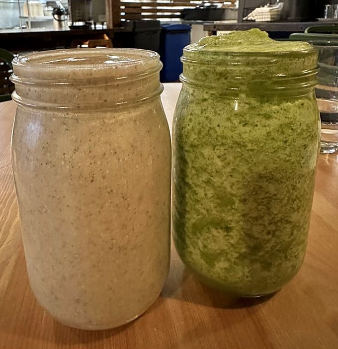 Two mason jars of smoothie perfection sit ready to deliver a one-two punch of nutrition and pure deliciousness to your taste buds.