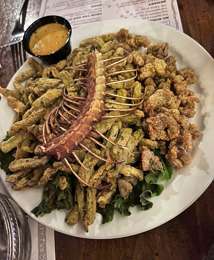 Not your average appetizer! Authentic rattlesnake arrives dramatically presented with its skeleton intact – a crunchy, unique delicacy that tastes surprisingly delicious.