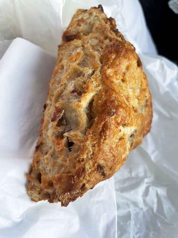 Behold the cheddar scone in all its golden glory, with a texture that's somehow both crispy and tender, like pastry magic.