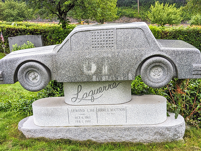 The Laquerre monument features a meticulously carved replica of a race car, immortalizing one man's passion for speed in permanent granite form.