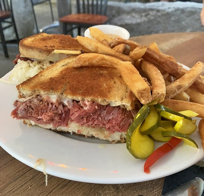The star attraction in all its glory &ndash; towering corned beef, melted Swiss, and tangy sauerkraut between perfectly grilled rye. Food poetry on a plate.