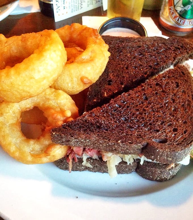 Behold the famous Reuben with golden onion rings, a sandwich so good it's worth planning your entire road trip around.