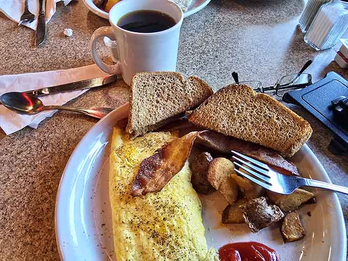 Classic breakfast done right: fluffy eggs, crispy bacon, golden toast, and home fries that understand their assignment perfectly.