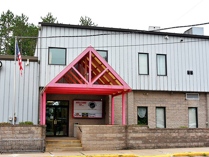 Riverside Athletic Club stands ready with its distinctive pink entrance, like a friendly neighbor inviting you in for some good-natured competition.