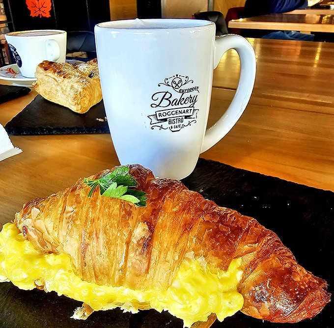 Breakfast perfection: A golden croissant filled with creamy scrambled eggs &ndash; simple ingredients transformed through European baking mastery.