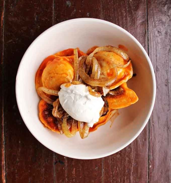 Golden-brown Polish dumplings arrive perfectly pan-fried, stuffed generously with traditional fillings that honor old-world cooking traditions.