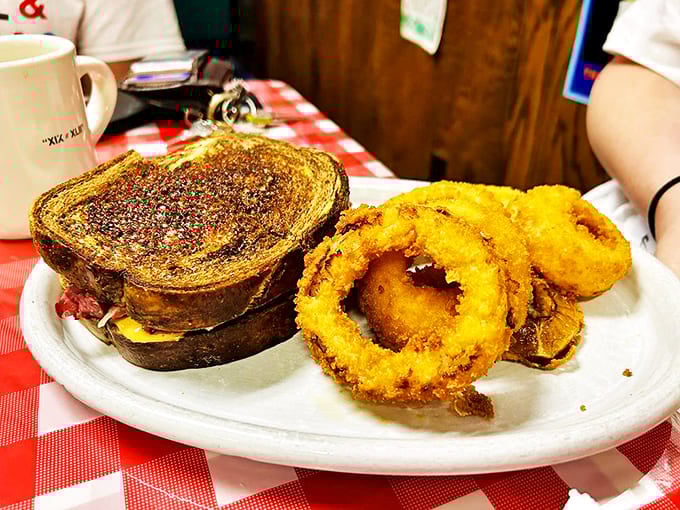 This Reuben sandwich and onion rings combo isn't just lunch – it's a commitment to excellence that your cardiologist might question.