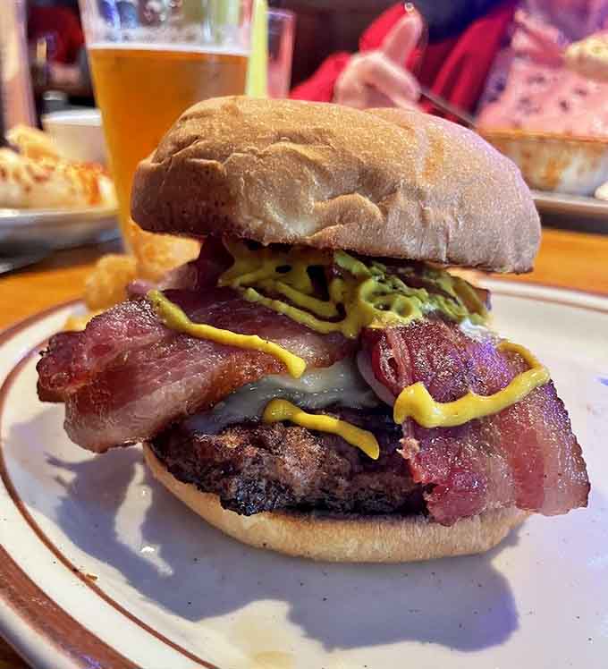 Behold the bacon cheeseburger in all its glory, stacked high and requiring both hands plus a game plan.