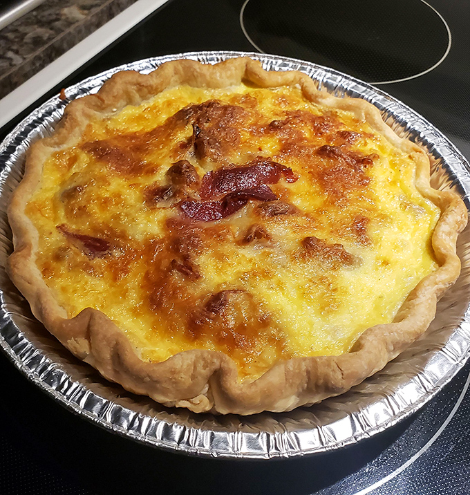 This isn't just any quiche&mdash;it's a masterclass in savory custard art. The bacon bits aren't playing around; they mean delicious business.