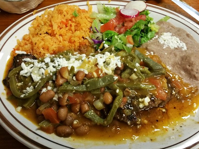 A classic Mexican plate featuring beans, rice, and vegetables alongside a hearty main dish &ndash; comfort food that speaks a universal language.