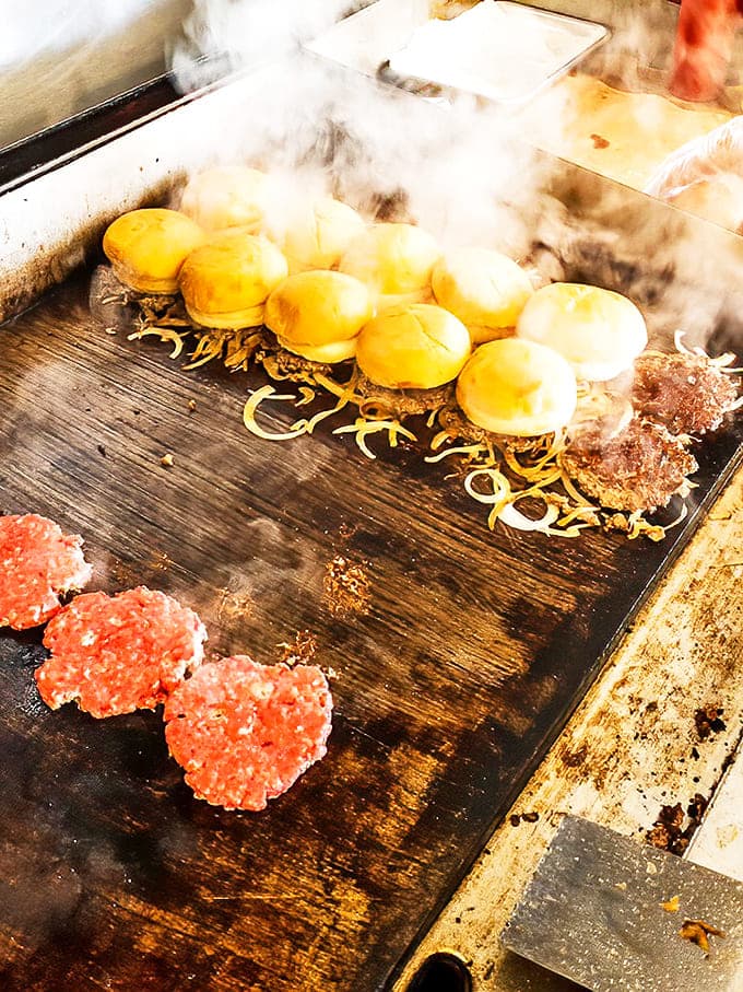 Steam rises as sliders sizzle on the flat-top, the dance of beef and onions creating an aromatic symphony that's pure Detroit.