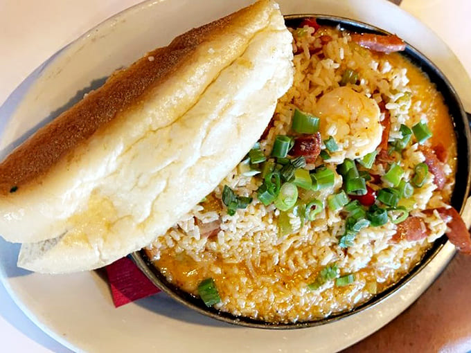 Golden jambalaya loaded with shrimp, sausage, and chicken, served with crusty French bread for maximum sauce-sopping satisfaction.