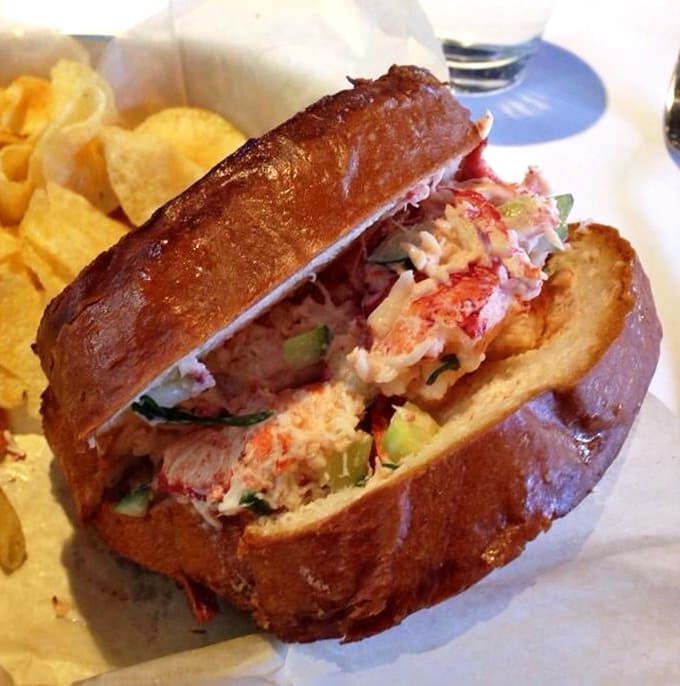 Behold the legend: a brioche bun barely containing its treasure of sweet lobster meat, proving Minnesota does seafood right.
