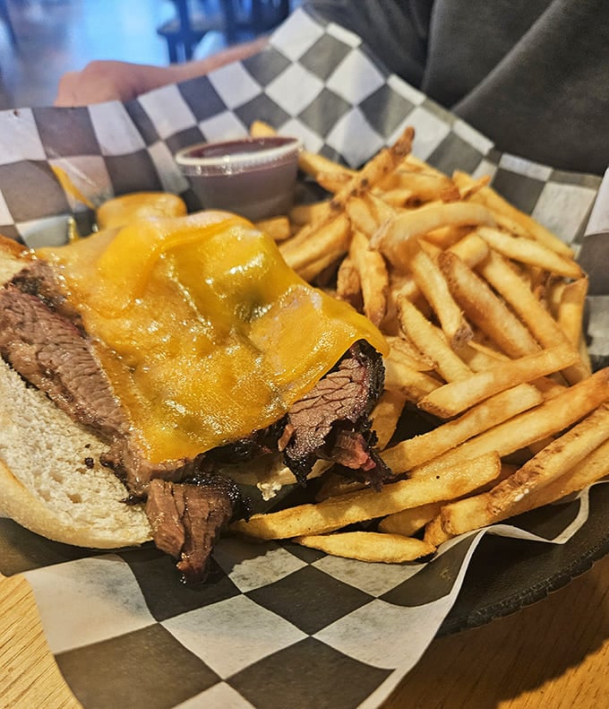 Behold the smoked brisket sandwich in all its glory, piled high with tender meat and served with fries that are crispy perfection incarnate.