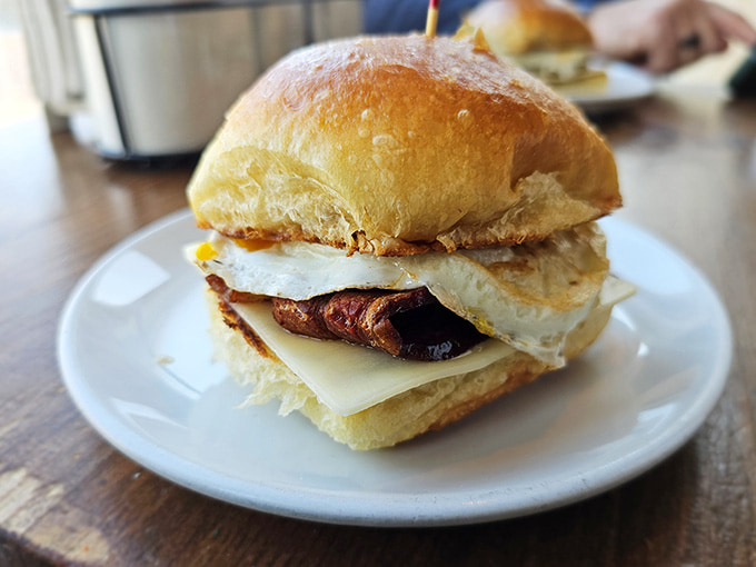 Behold the breakfast sandwich perfection: fluffy brioche cradling egg and cheese in a handheld morning masterpiece.