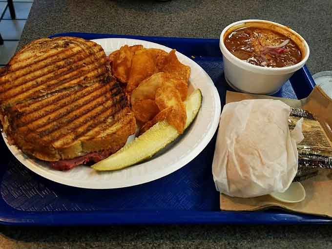 The famous Reuben in all its glory, with corned beef piled high between perfectly grilled marble rye that's basically edible gold.