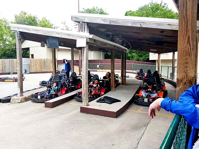 Drivers await their turn at the starting gates, engines humming with potential energy about to be unleashed.