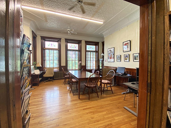 Study Area: A sunlit sanctuary where thoughts flow freely across international lines, wooden chairs waiting patiently for curious minds from either country.