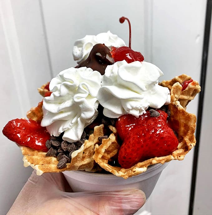 Sundae: Architecture in edible form &ndash; fresh strawberries nestled in vanilla clouds, crowned with whipped cream. Summer captured in a paper cup.