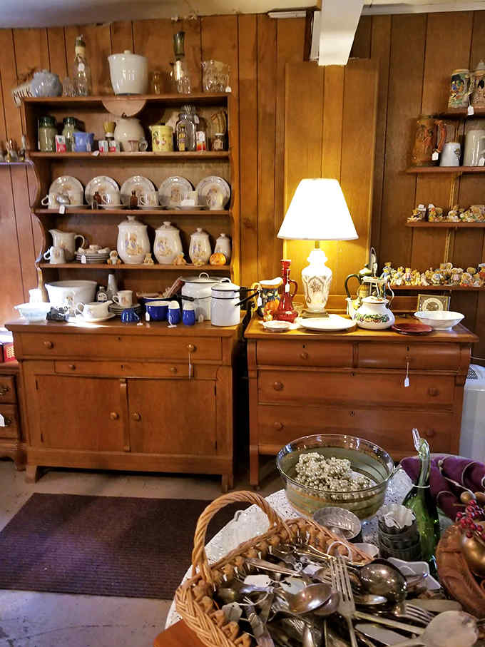 Delicate china and sturdy kitchenware share space on antique dressers, each piece whispering stories of family dinners and special occasions past.